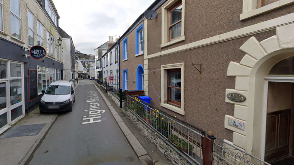 Crews fight bin fire that spread to building in East Looe - BBC News