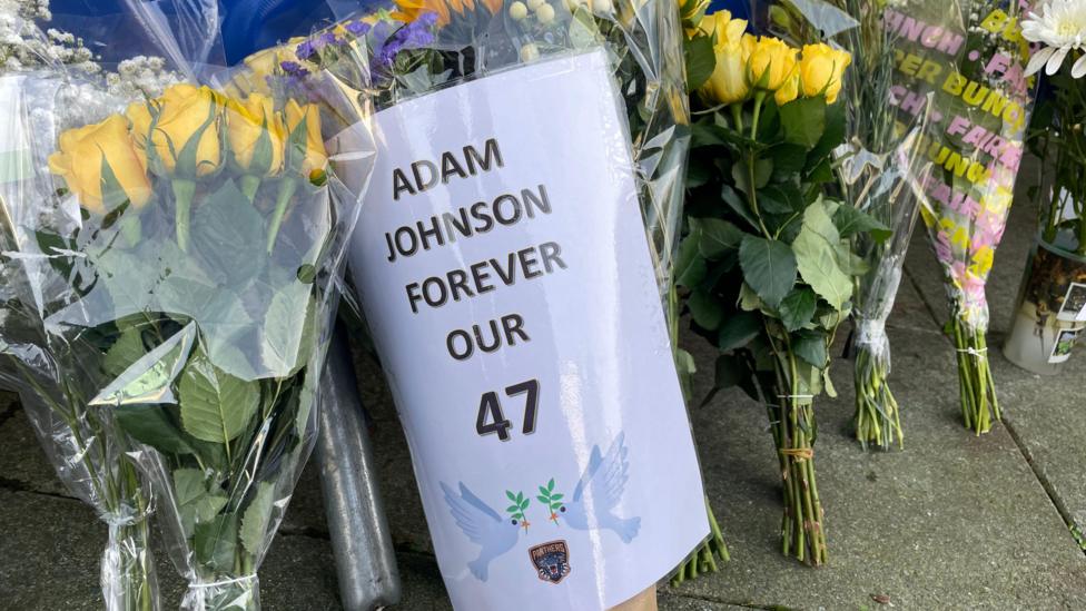 Fans pay tribute to ice hockey player Adam Johnson one year on - BBC News