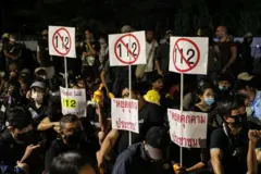 BANGKOK, THAILAND - NOVEMBER 29: Protesters carry placards with messages demanding the repeal of section 112 of the criminal code, which deals with Lese Majeste offenses, outside the headquarters of the 11th Infantry Regiment on November 29, 2020 in Bangkok, Thailand. Protesters marched to the headquarters of the Royal Thai Army's 11th Infantry Regiment, which also a King's Guard regiment. (Photo by Lauren DeCicca/Getty Images)