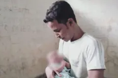 হাজতখানায় অভিযুক্ত ব্যক্তির কোলে শিশু