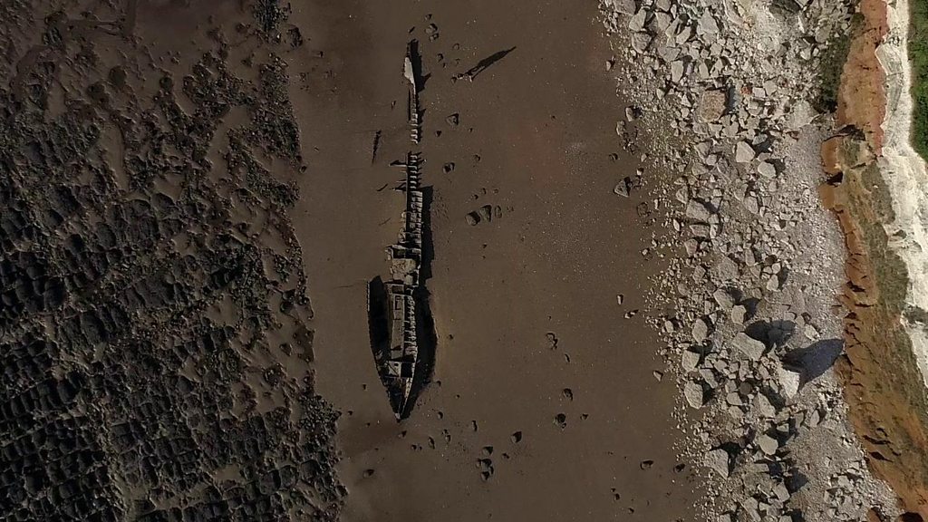 Photos show impact of time on Norfolk beach wreck - BBC News