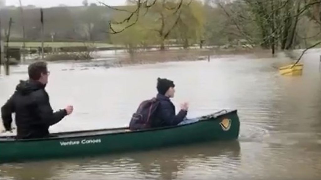 Flood rescues after two people get trapped in cars - BBC News