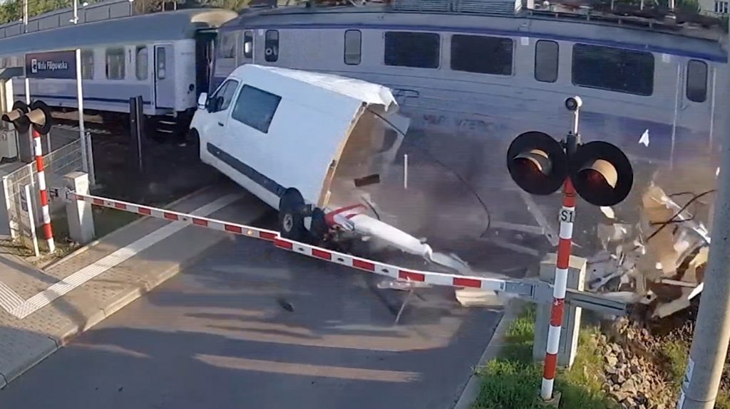 Van driver survives train collision at level crossing