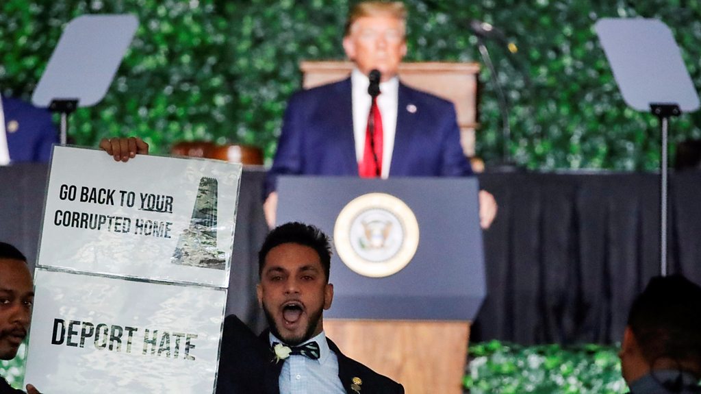 Protester interrupts President Trump's democracy speech
