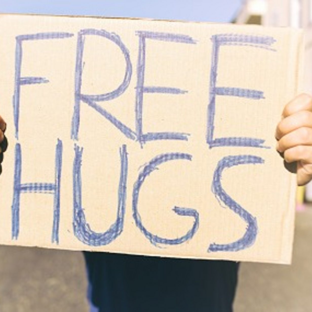 Free Hugs Sign By Free Hugs Written On Colorful Background Stock Photo