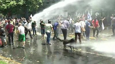 Public workers clash with Chile police in Santiago protest - BBC News