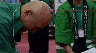 Japanese bald men celebrate pull factor with special tug of war - BBC News