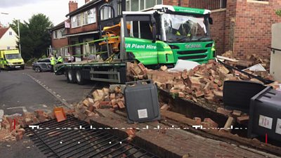 CCTV shows low-loader crashing into shop front - BBC News
