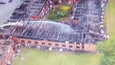 Drone footage shows Holiday Inn destroyed by fire - BBC News
