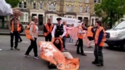 Just Stop Oil protester dragged along road by police officer - BBC News