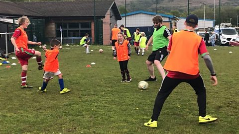 Autistic footballer realises dream as he joins mainstream team - BBC News