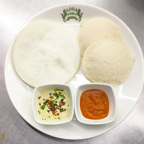Idli: Steamed rice cakes with lentils
