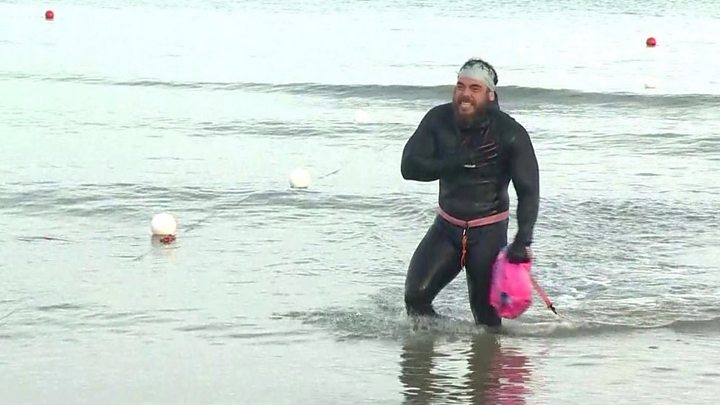 Ross Edgley sets record for round Great Britain swim - BBC News
