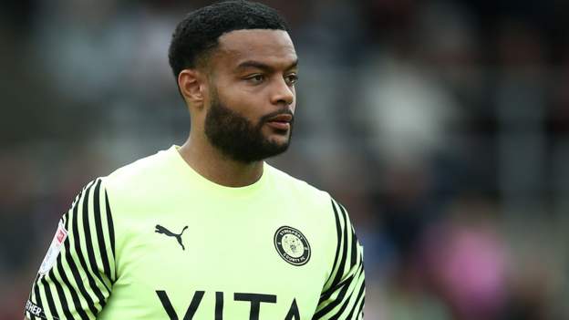 Ryan Johnson: AFC Wimbledon sign defender after Stockport exit - BBC Sport