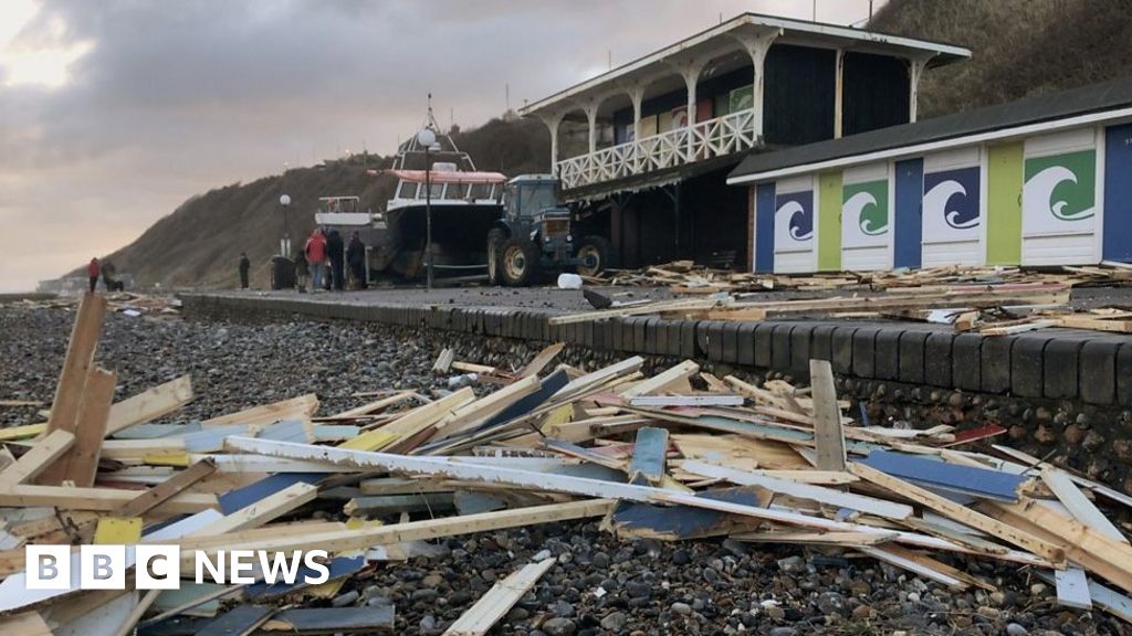 Storm surge: Cromer Pier damaged and beach huts destroyed - BBC News
