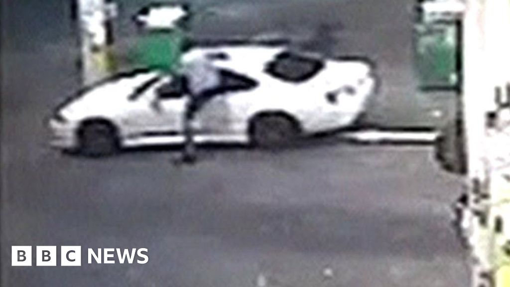 Motorist jumps through window to stop thief - BBC News