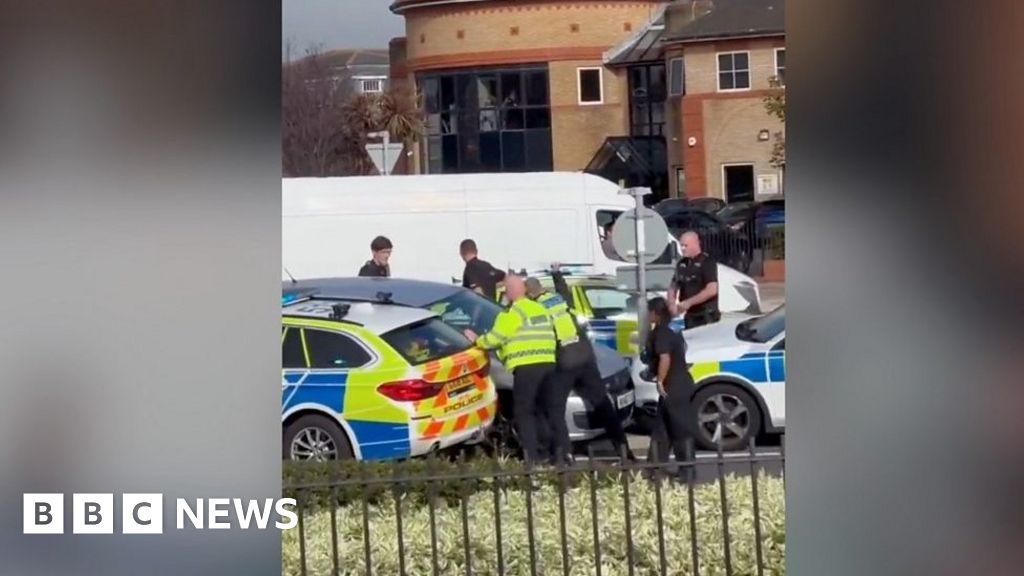 Watch: Multiple officers arrest suspect after police chase - BBC News