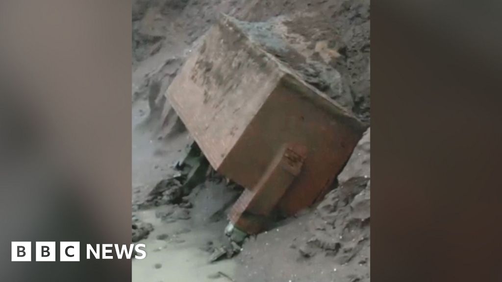 Drone footage shows cliff edge nuclear bunker now resting on beach ...