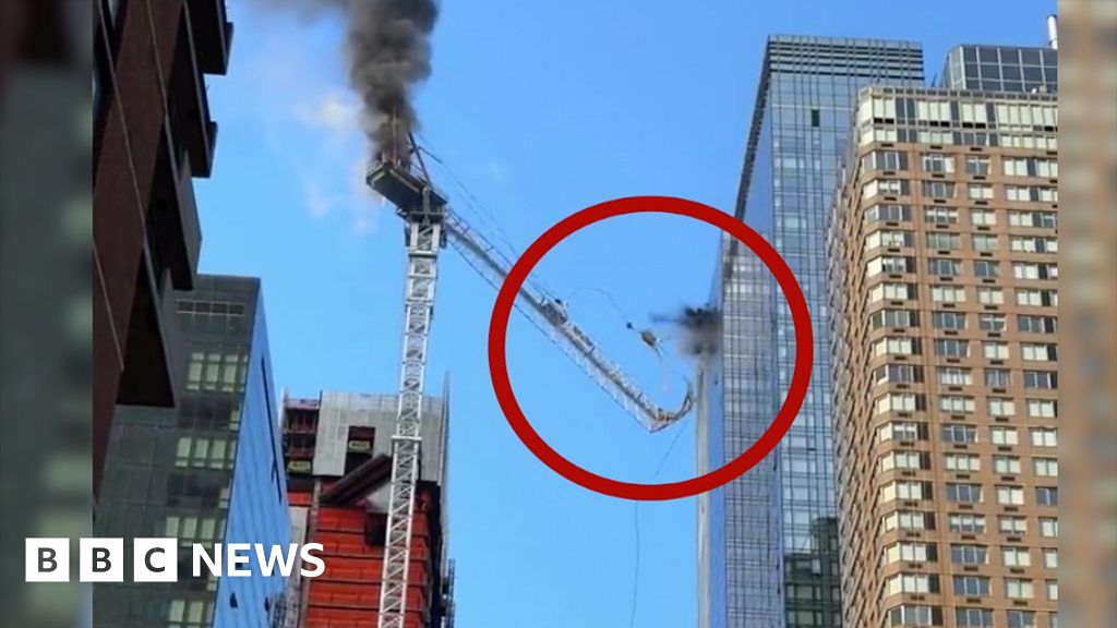 The moment an NYC crane catches fire and collapses - BBC News