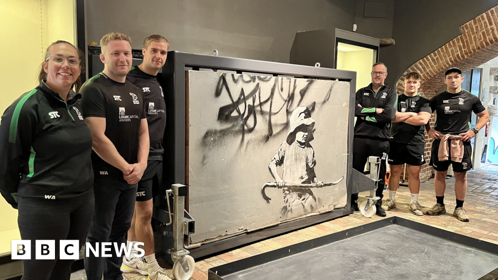 Bury St Edmunds rugby players help lift Banksy from museum