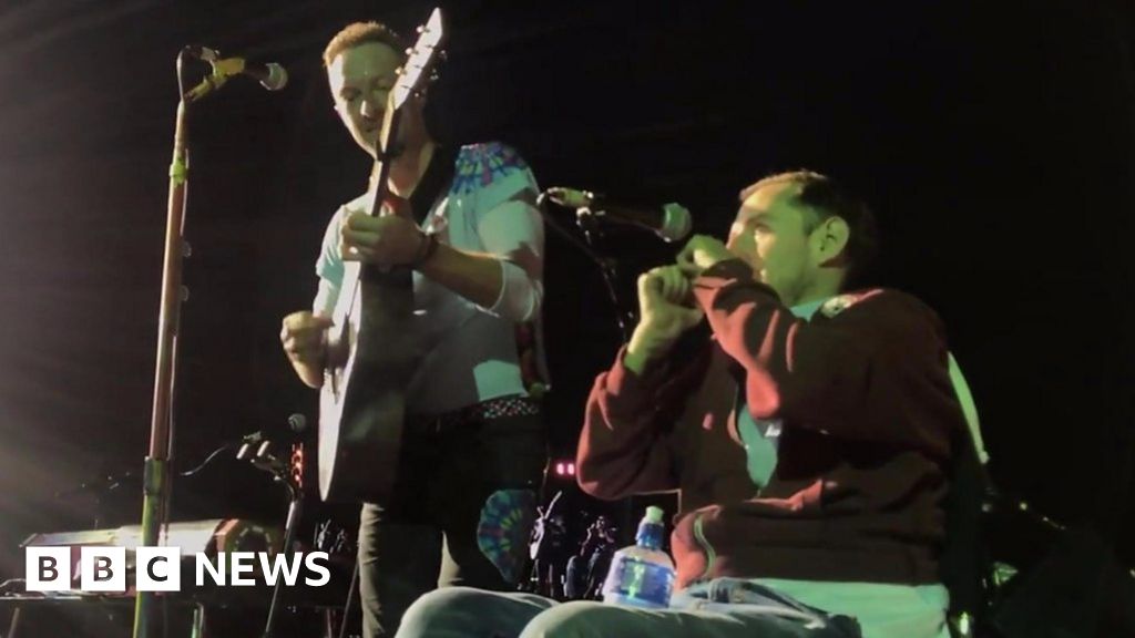 Disabled fan's on-stage performance with Coldplay - BBC News