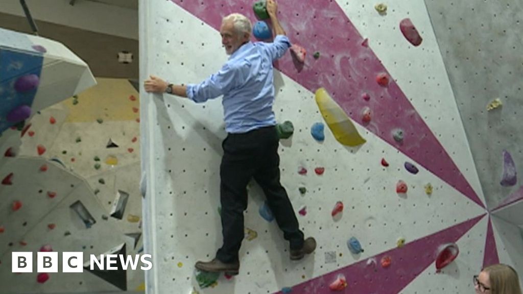 Labour leader Jeremy Corbyn scales a climbing wall - BBC News