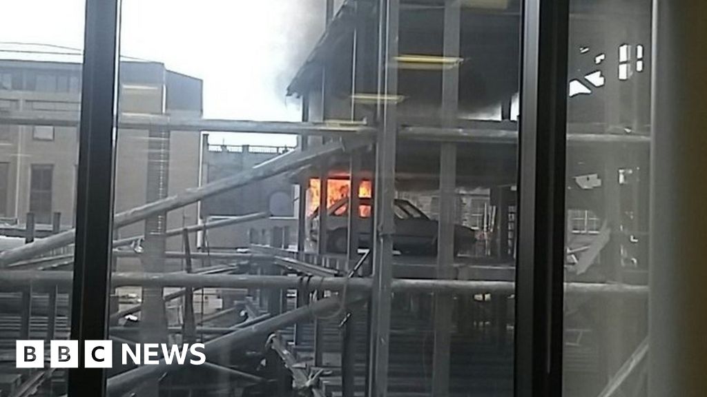 Abandoned cars on fire in derelict robot car park - BBC News