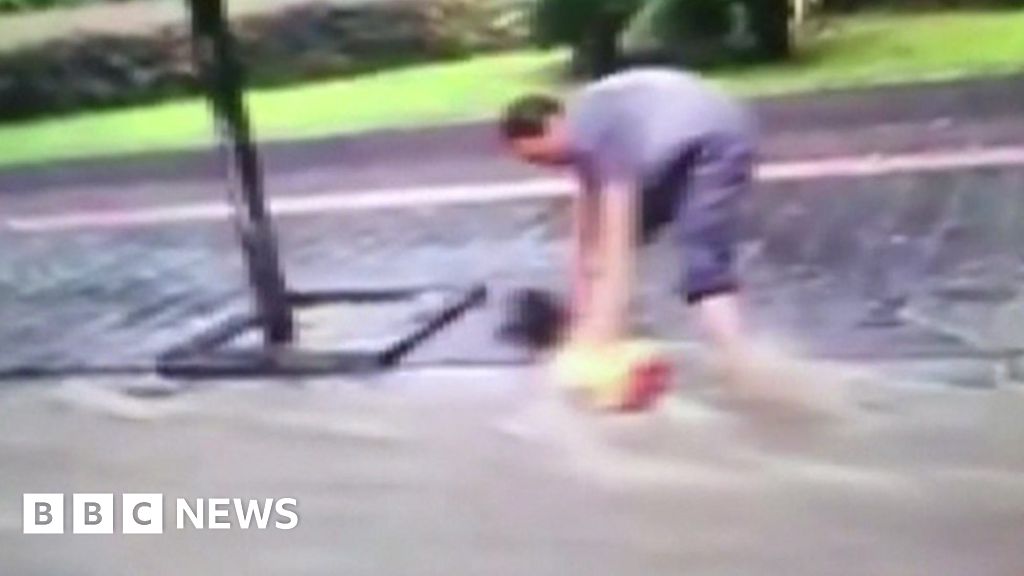 Passerby rescues child from fast-moving flood waters - BBC News