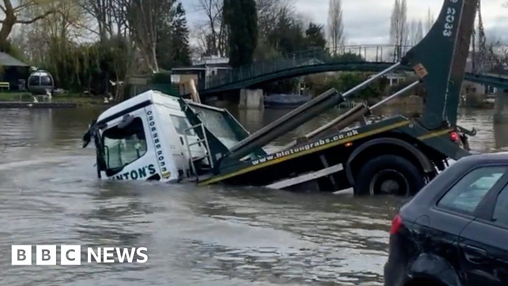 River Thames: Driver rescued after skip lorry slips into water near ...