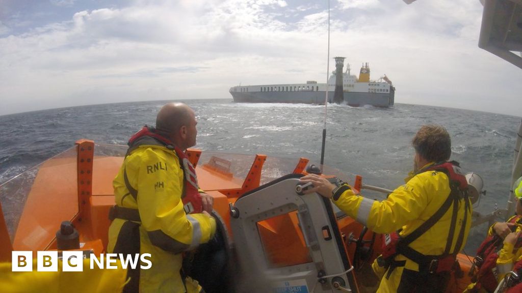 Cargo ship towed to safety after grounding near lighthouse - BBC News