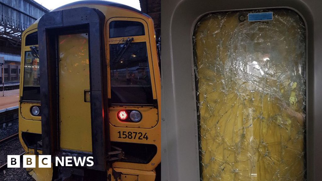 Train damaged by traffic cone thrown from bridge - BBC News