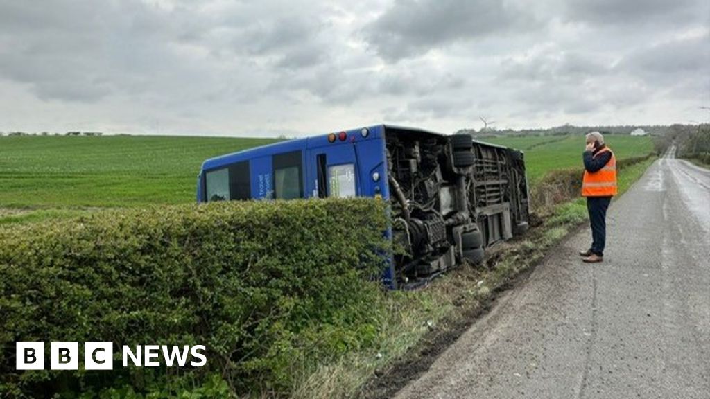 Double-decker bus overturns into field near Stanley - BBC News