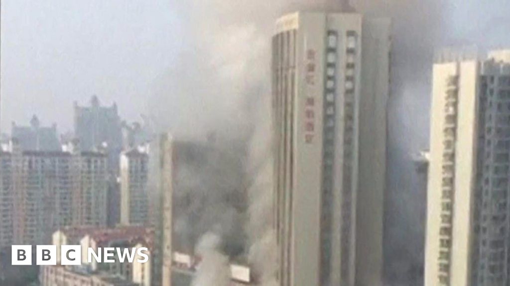 Fire crews in China battle tower block blaze - BBC News