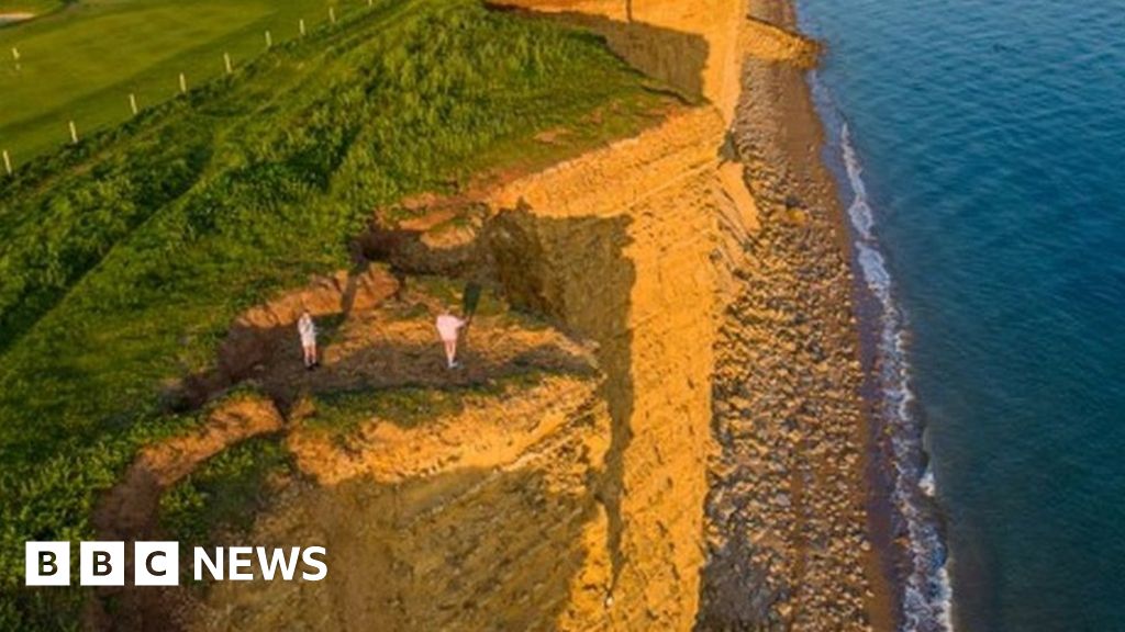 Jurassic Coast: Youngsters pose for photos on rock fall cliff edge ...