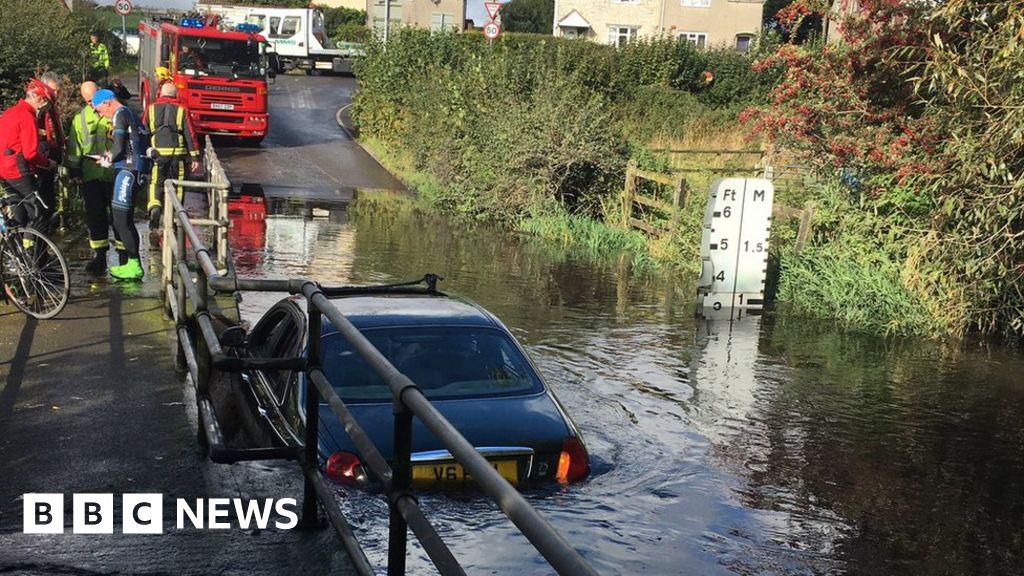 Cyclists rescue three from car at flooded ford - BBC News