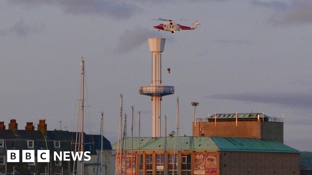 Helicopter crew honoured for Weymouth Jurassic Tower rescue - BBC News
