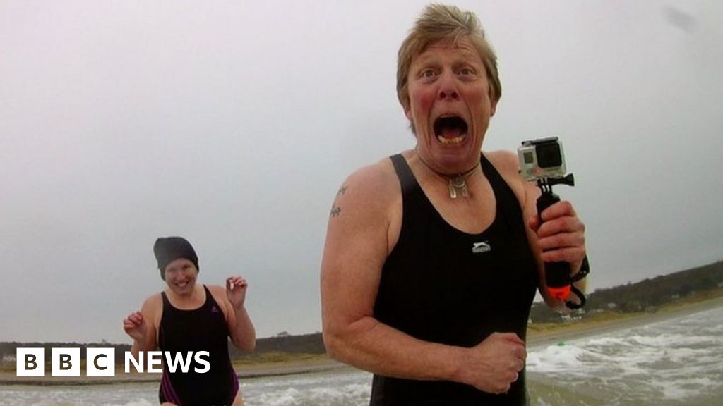 Women cold water swimming in Gower to help menopause - BBC News