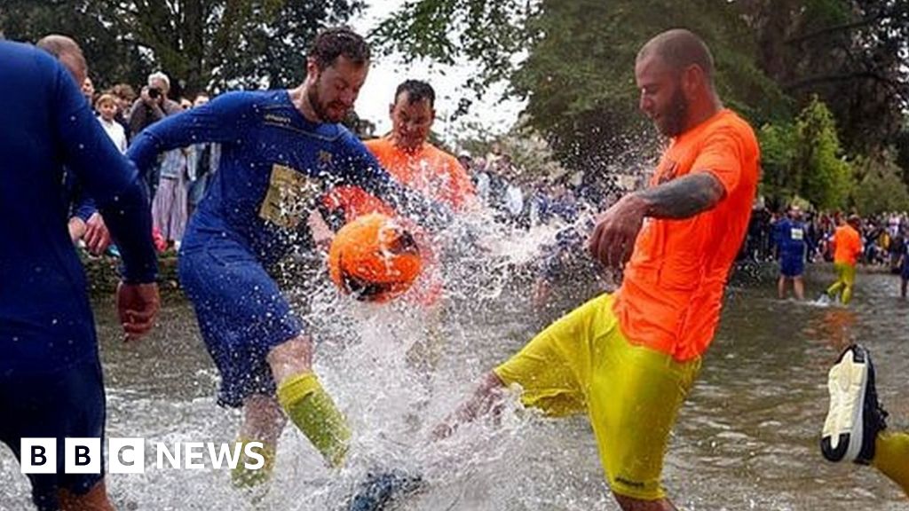 Bourton-on-the-Water crowds gather to watch river football match