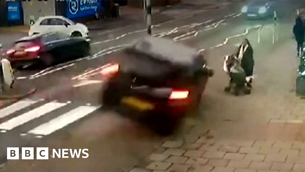 Solihull: Car flips and narrowly misses woman with child
