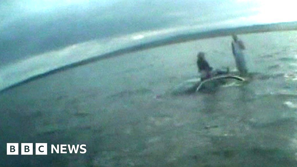 Pair rescued from submerged car - BBC News