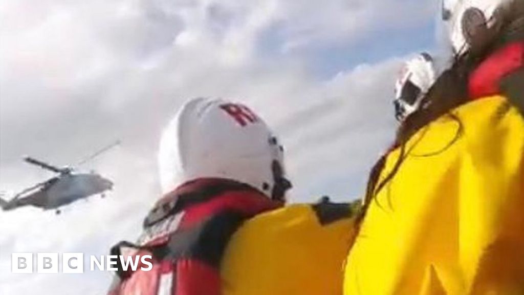 Young paddleboarder rescued by RNLI lifeboat crew - BBC News