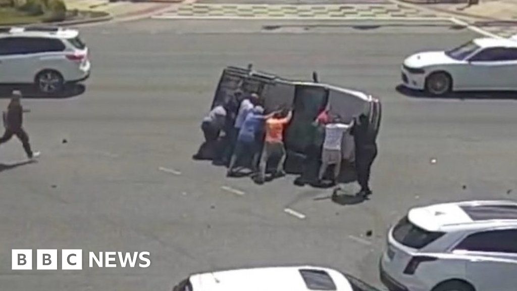 Bystanders rush to flip overturned car after accident