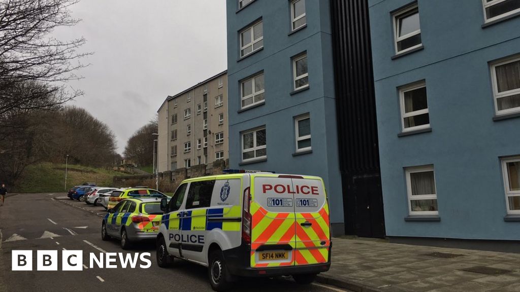 Police launch probe after woman falls from block of flats