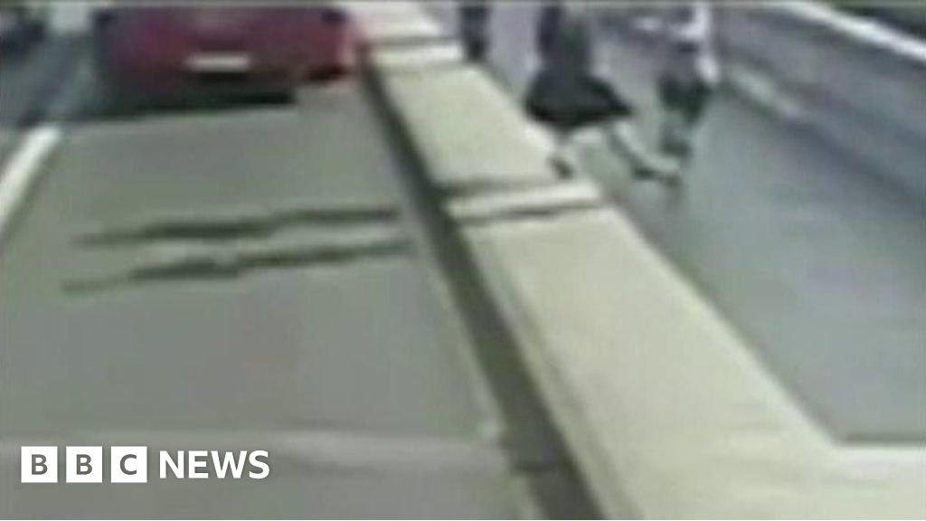 A London bus narrowly avoids a woman who appears to be pushed over by a ...