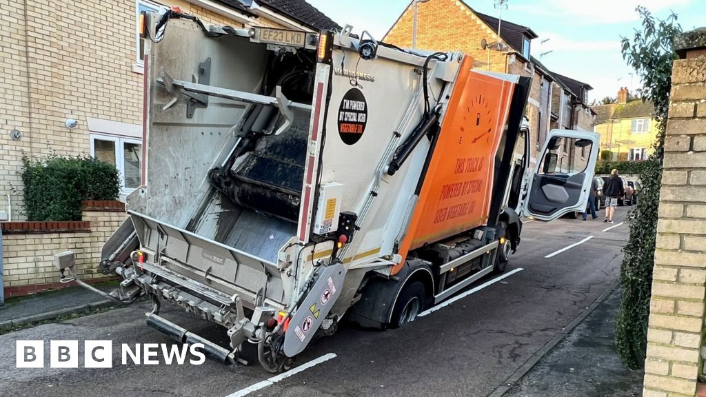 Bin lorry stuck in Stowmarket after road collapses underneath - BBC News