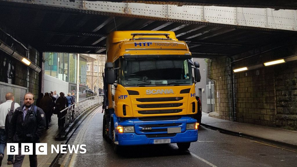 Lorry gets stuck under Cardiff railway bridge - BBC News