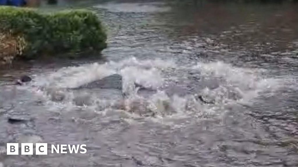 Street damaged by flash flooding after heavy rain