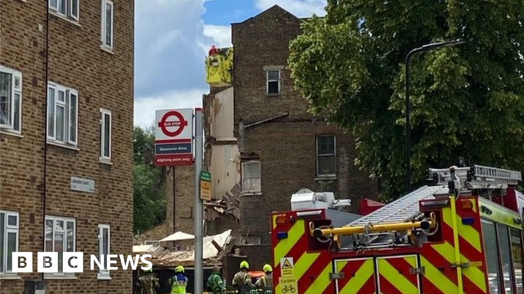 Shock as back of three-storey house collapses in Hackney - BBC News