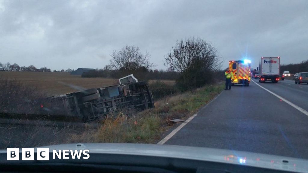 Lorry crashes in M11 ditch in Essex as driver 'blacks out' - BBC News