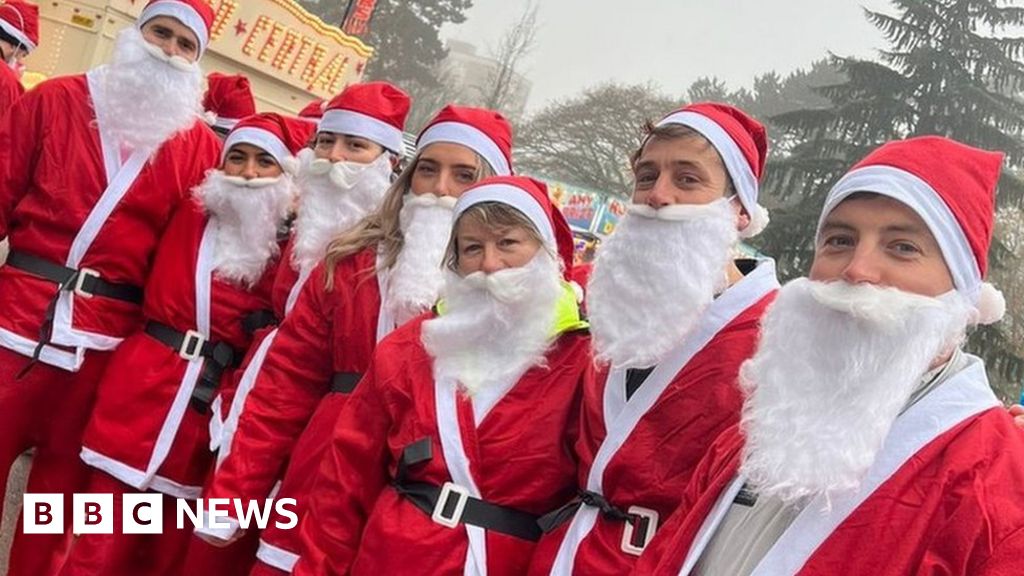 Hundreds of Santas join festive Wolverhampton fundraiser - BBC News